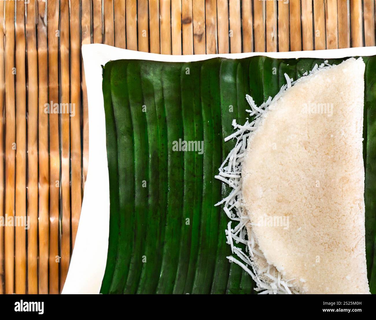 Traditional Brazilian tapioca with coconut served on a banana leaf ...