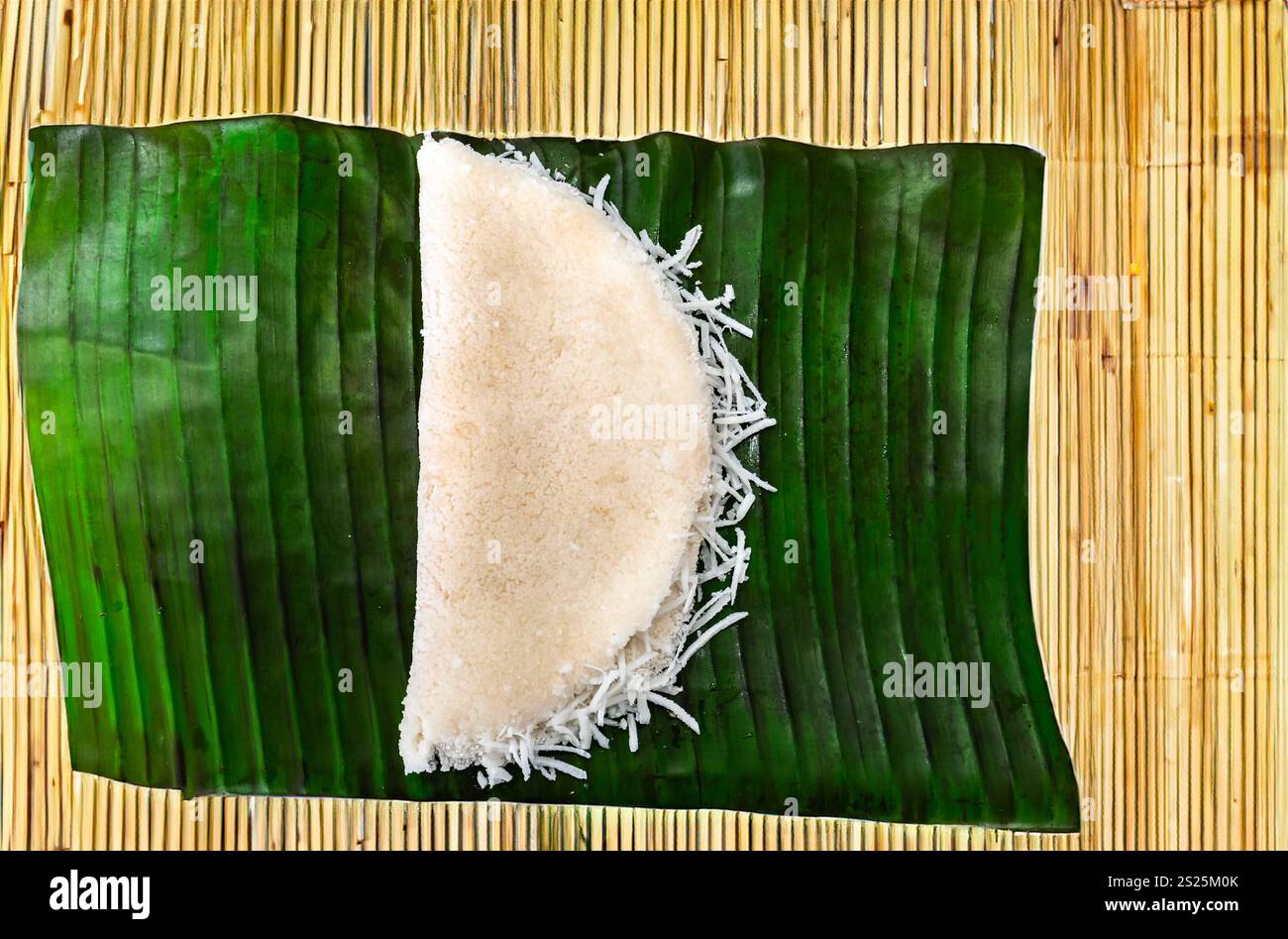 Traditional Brazilian tapioca with coconut served on a banana leaf ...