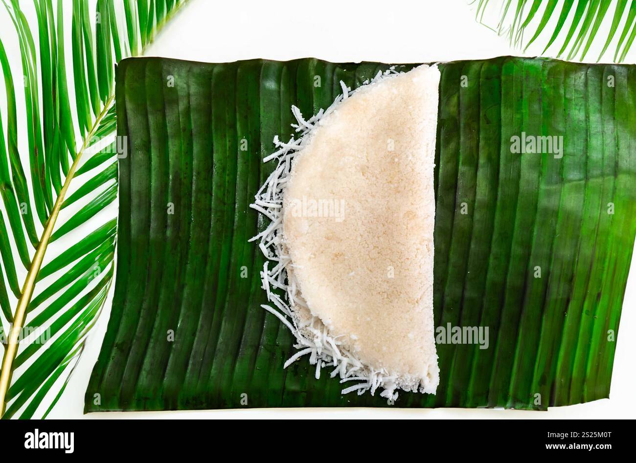 Traditional Brazilian tapioca with coconut served on a banana leaf ...
