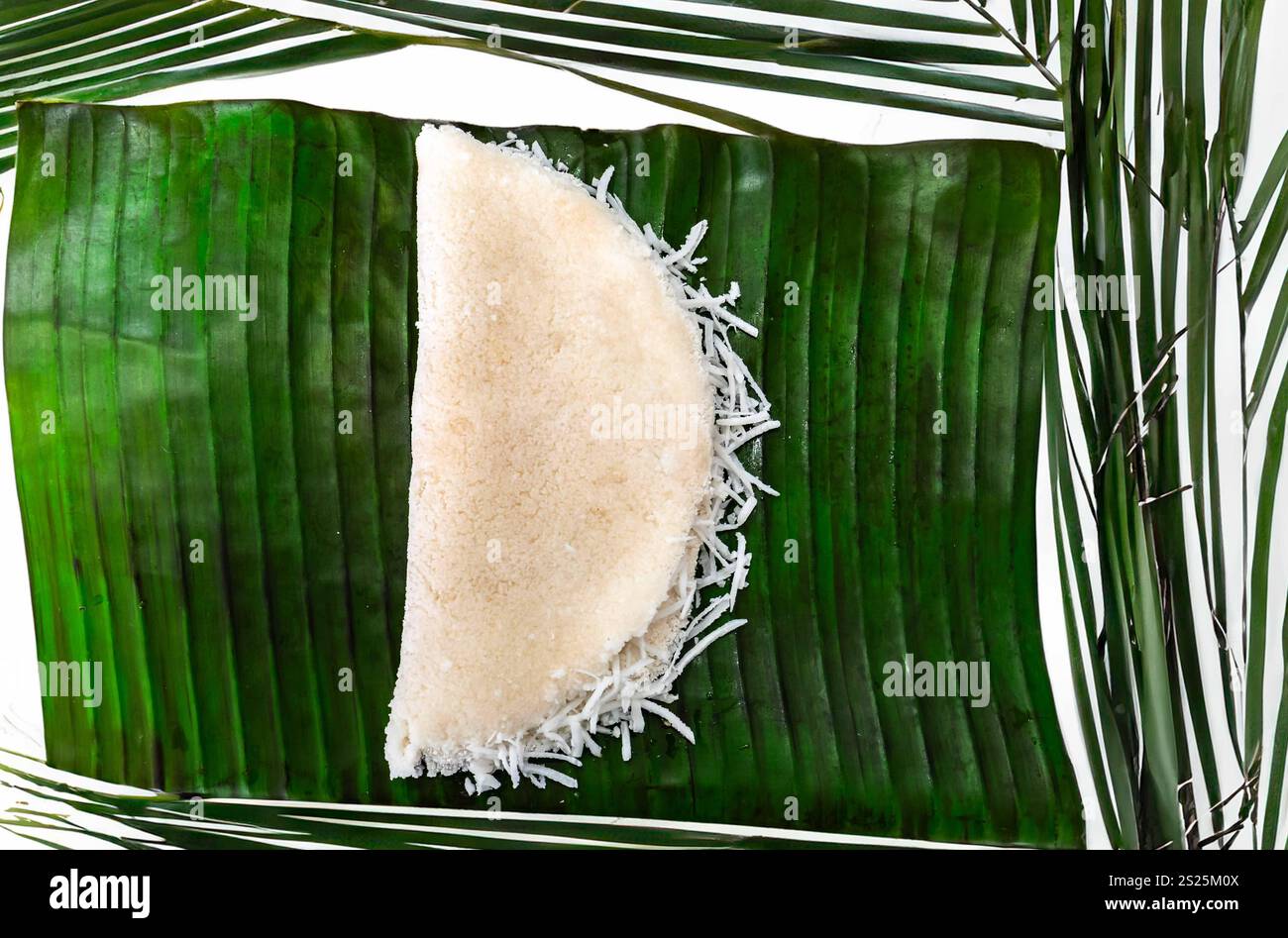 Traditional Brazilian tapioca with coconut served on a banana leaf ...