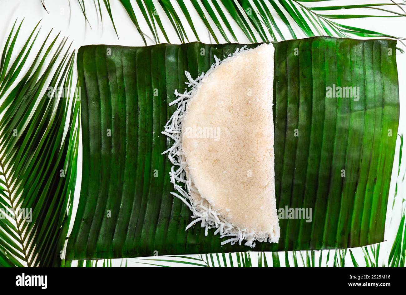 Traditional Brazilian tapioca with coconut served on a banana leaf ...