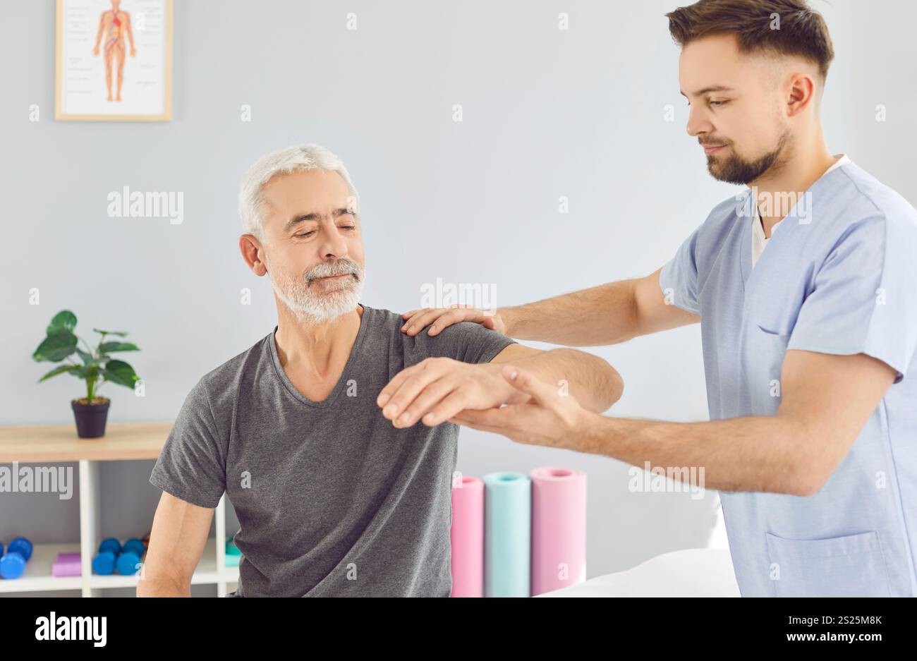 Physiotherapist helps mature man regain elbow mobility during ...