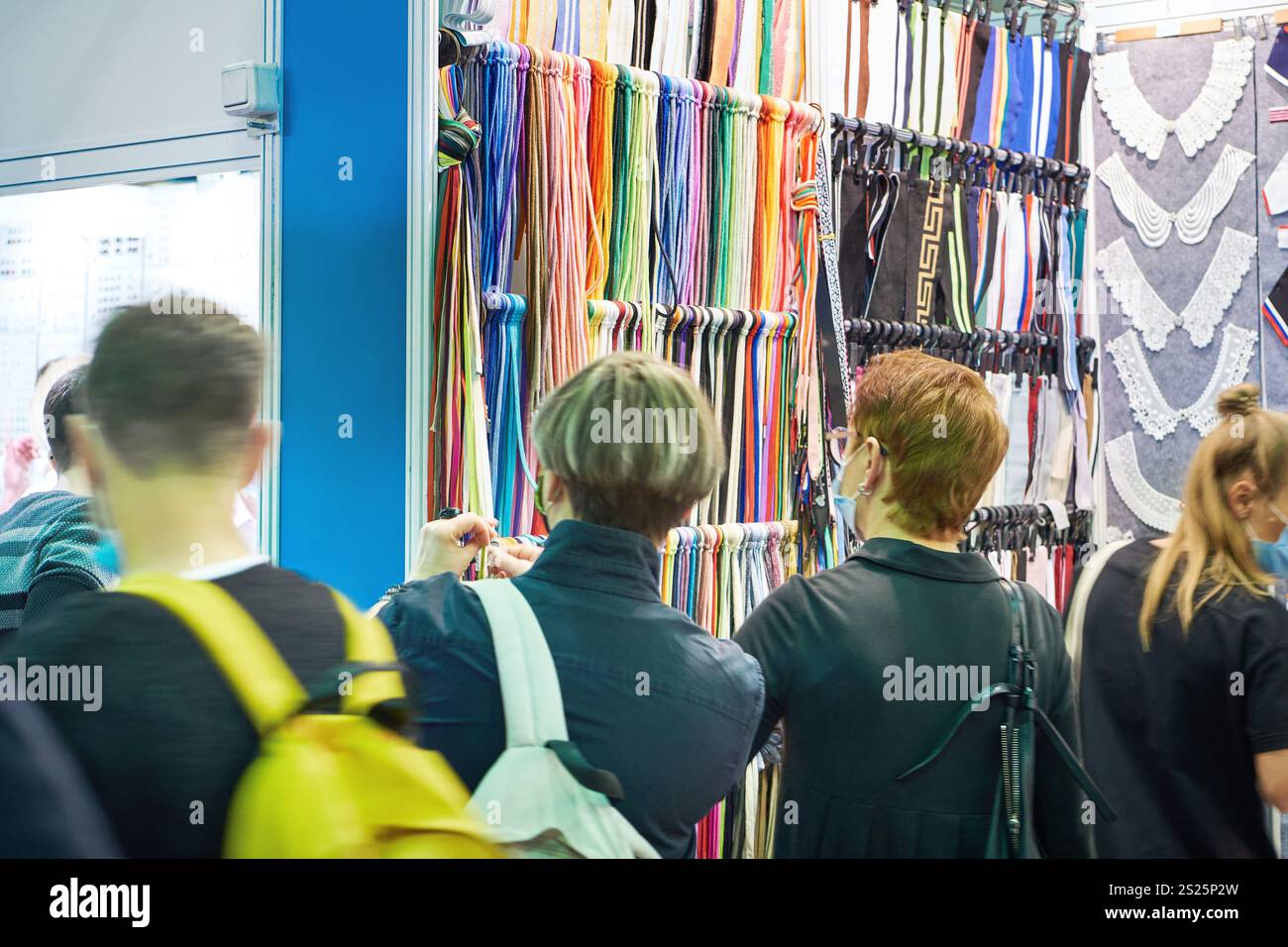 Shoppers choose laces, ribbons and accessories at the market of a ...