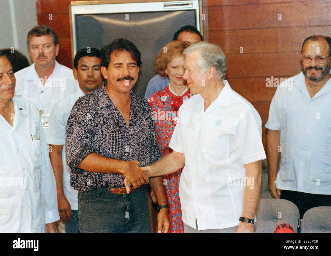 FILE - Former U.S. President Jimmy Carter, right, shakes hands with ...