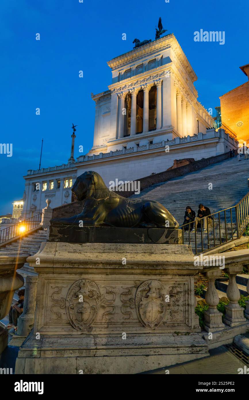 A basalt Egyptian lion statue with the Monument to Victor Emmanuel II ...