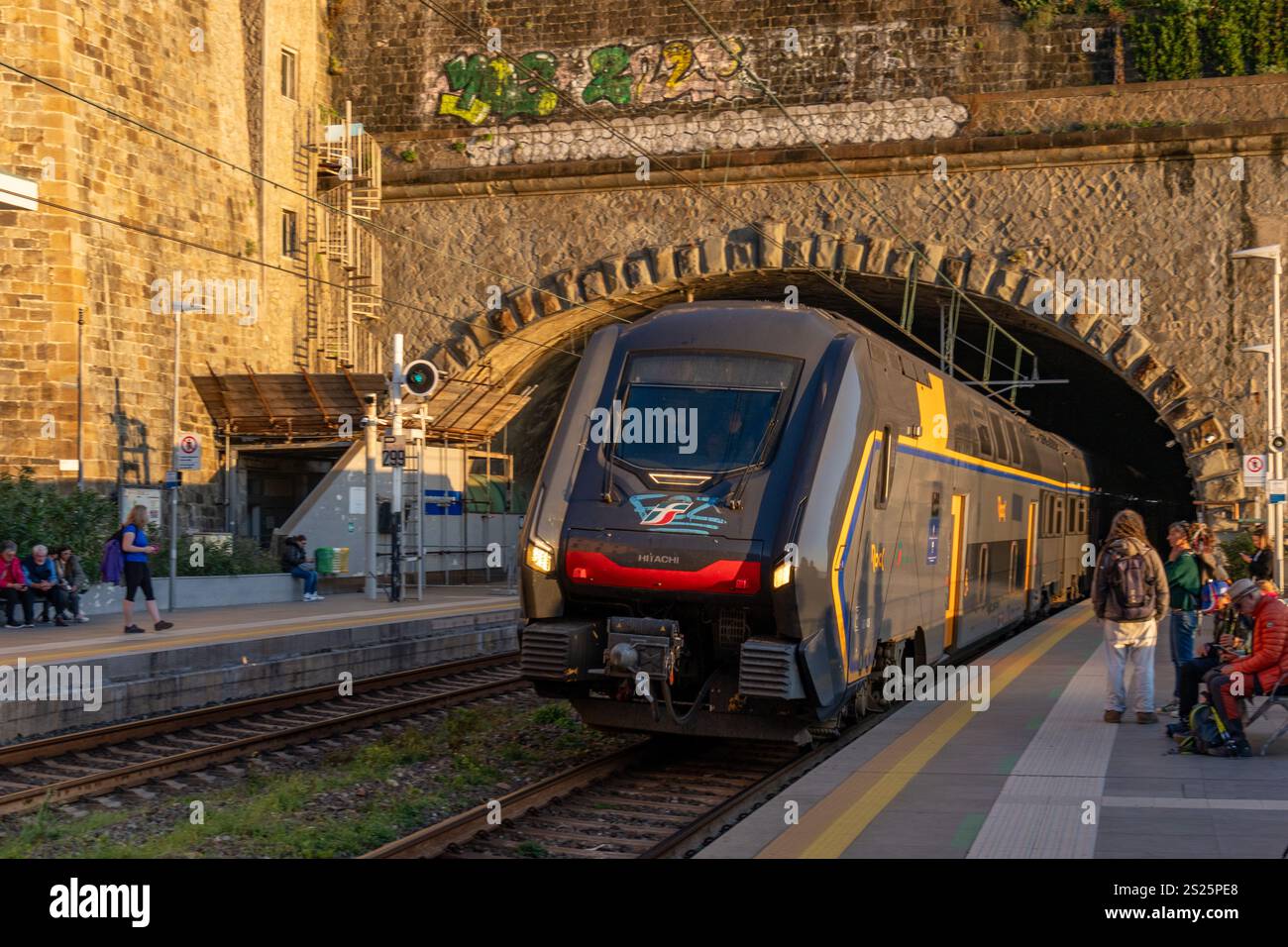 The Trenitalia Rock passenger train exits a tunnel at the station in ...