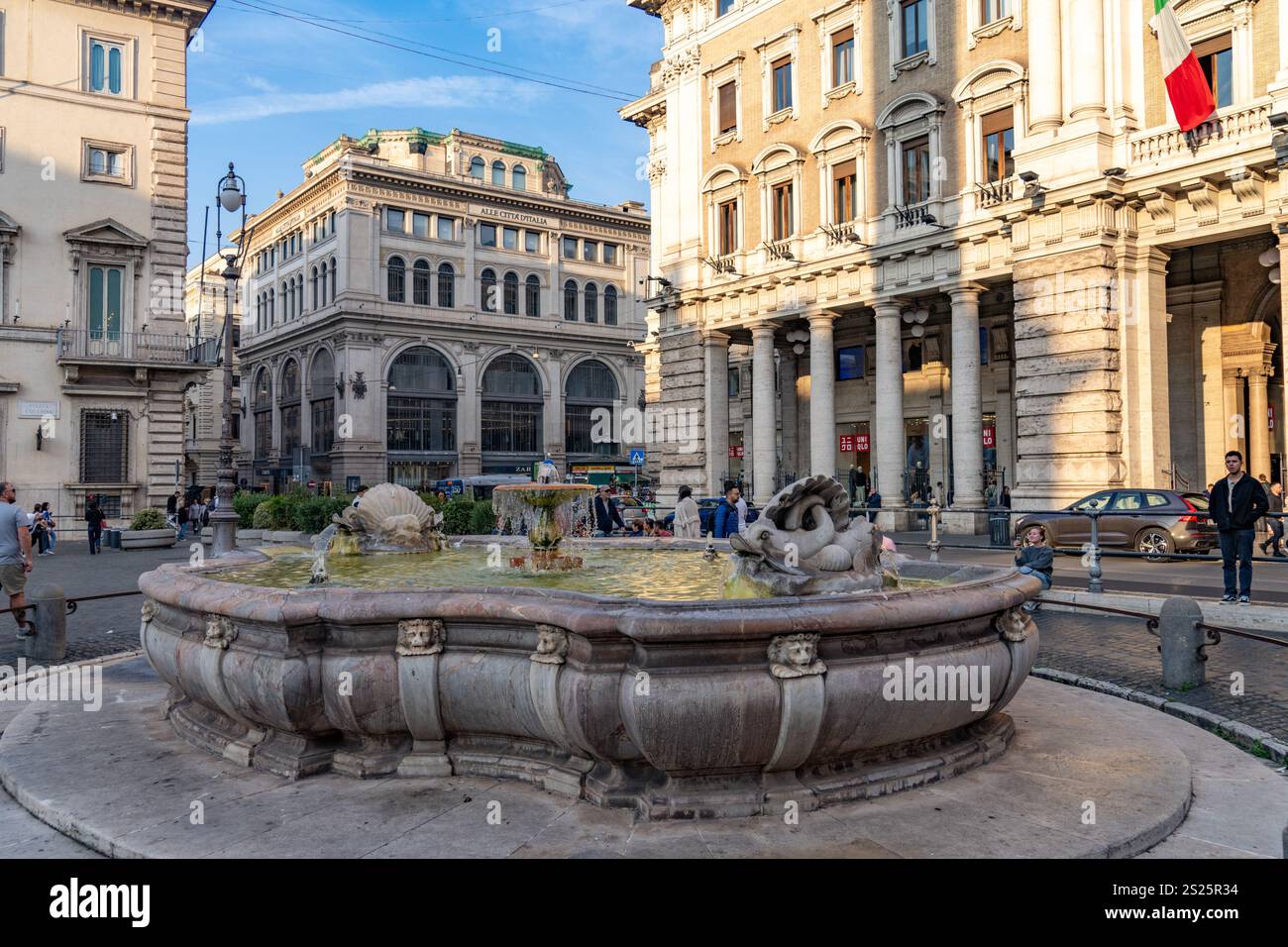 Carved stone dolphins in the fountain in the Piazza Colonna in Rome ...