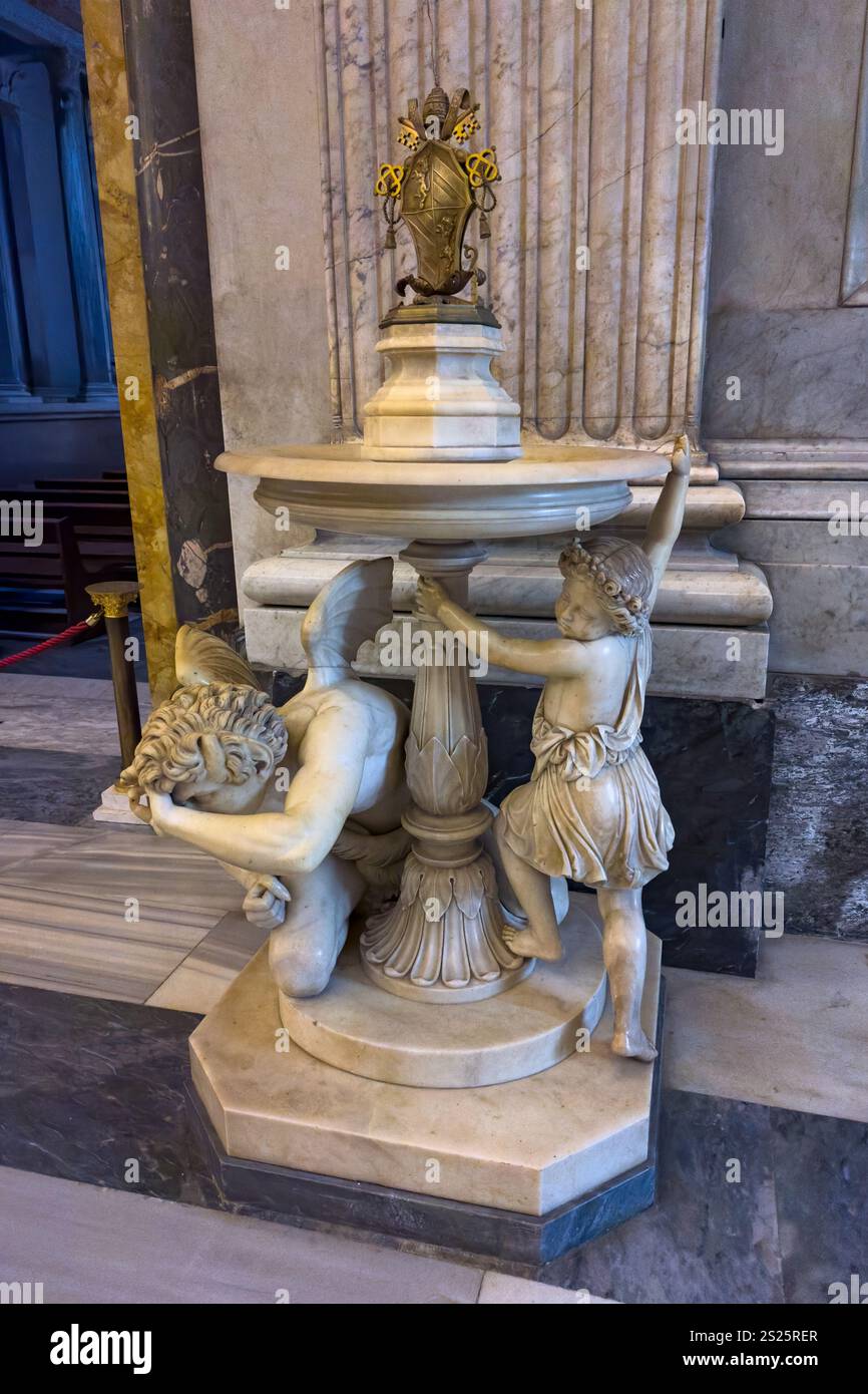 Sculpture of a devil cowering under a stoup of Holy Water in the ...