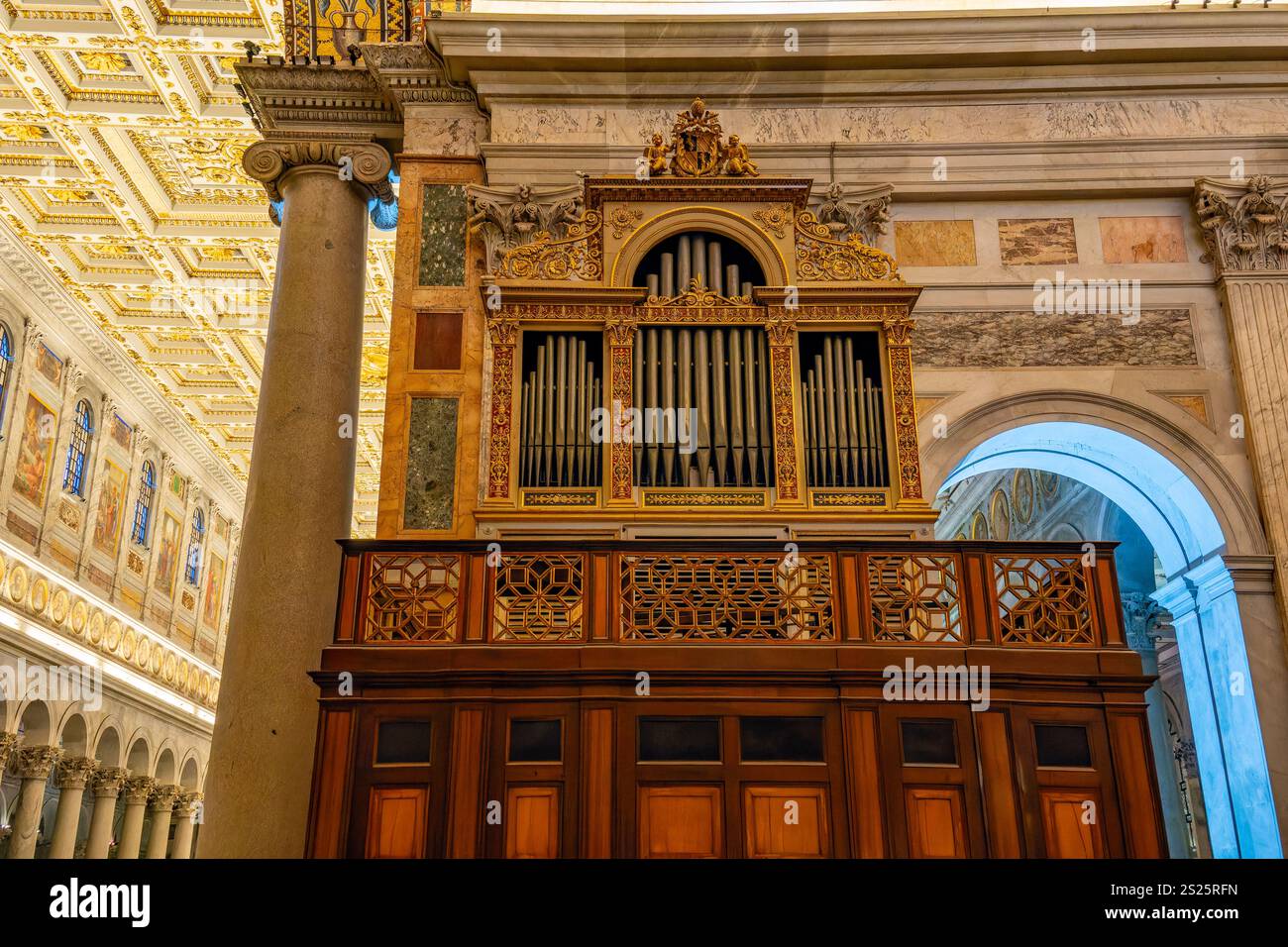 An ornate antique pipe organ in the transept of the Basilica of St ...