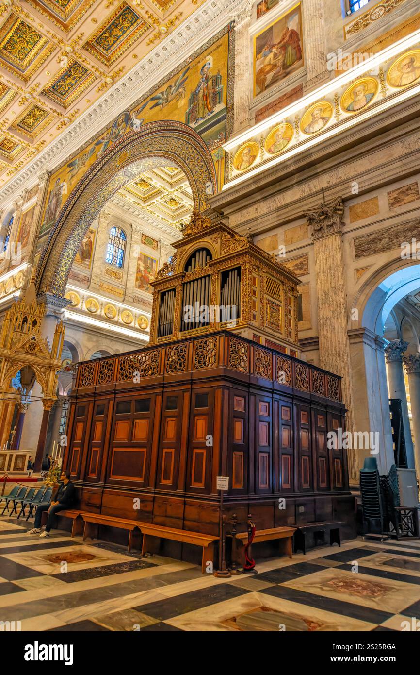 An ornate antique pipe organ in the transept of the Basilica of St ...