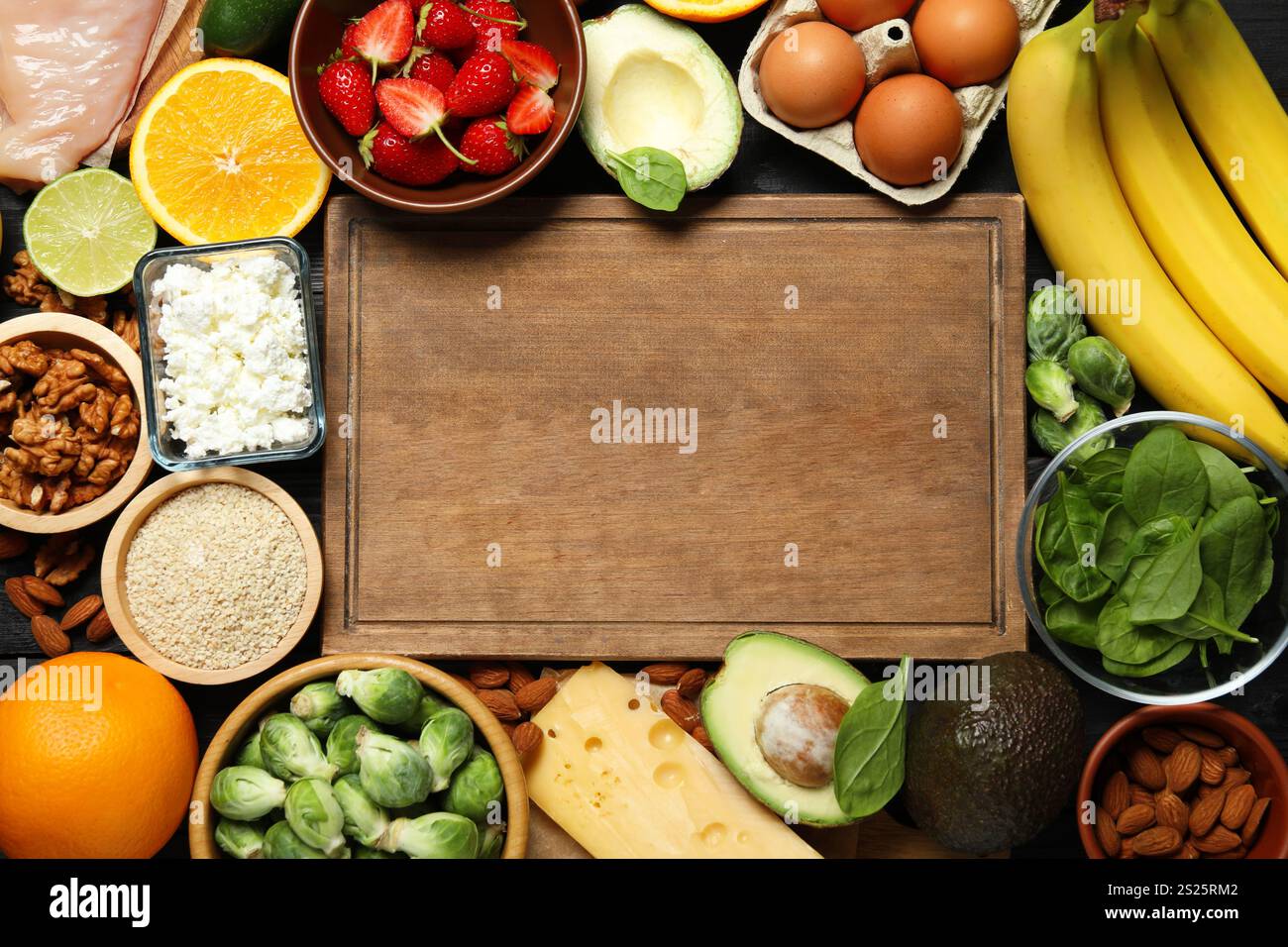 Wooden board and different products rich in dopamine as background ...