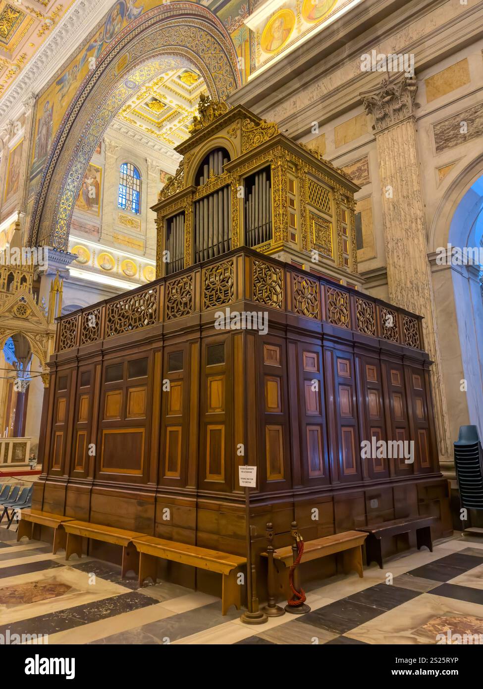 An ornate antique pipe organ in the transept of the Basilica of St ...