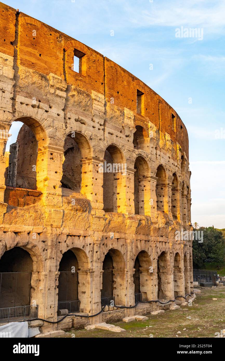 The ancient Roman Colosseum or Flavian Amphitheater with golden sunset ...