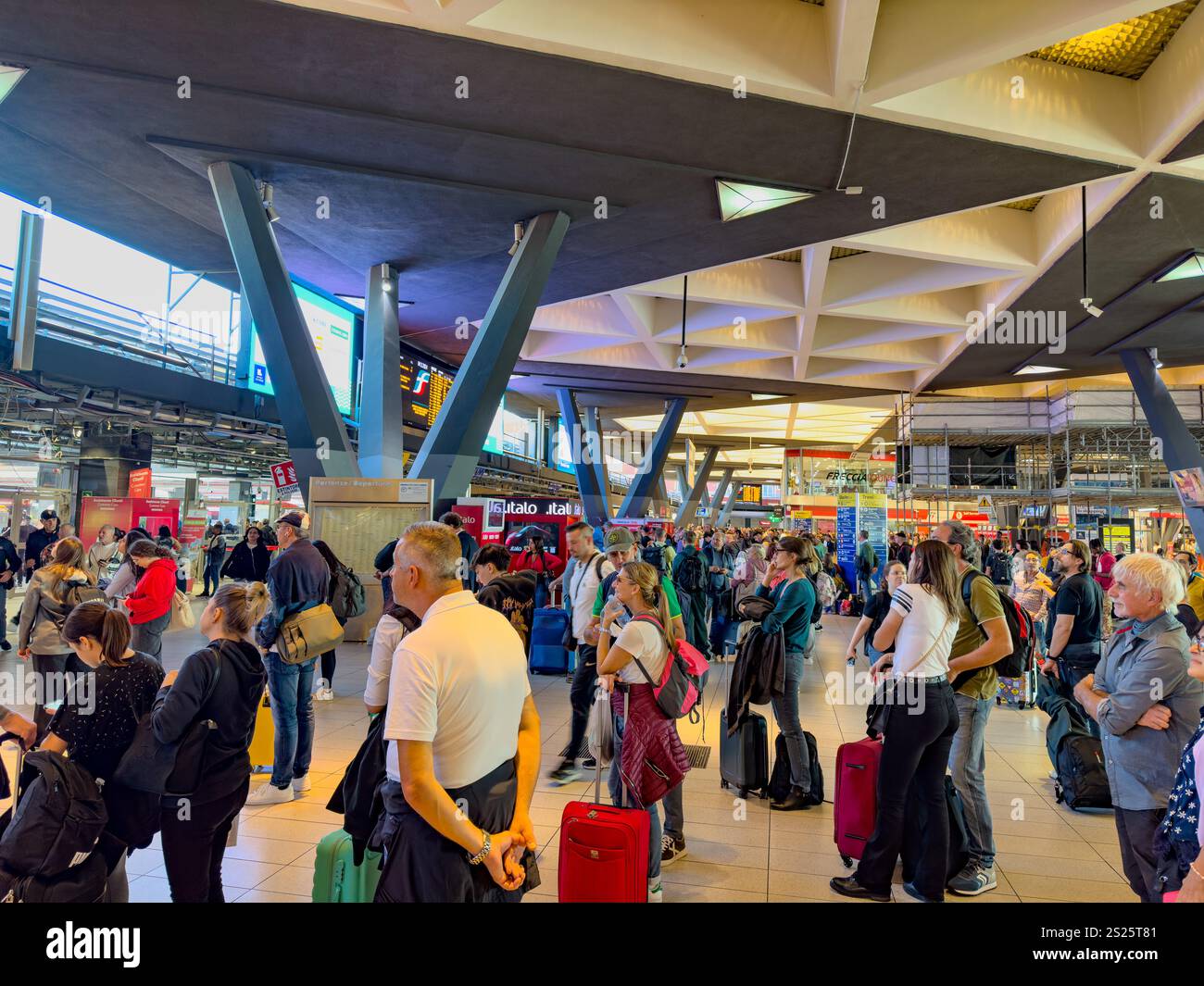Passengers wait for their trains in the Central Train Station in Naples ...