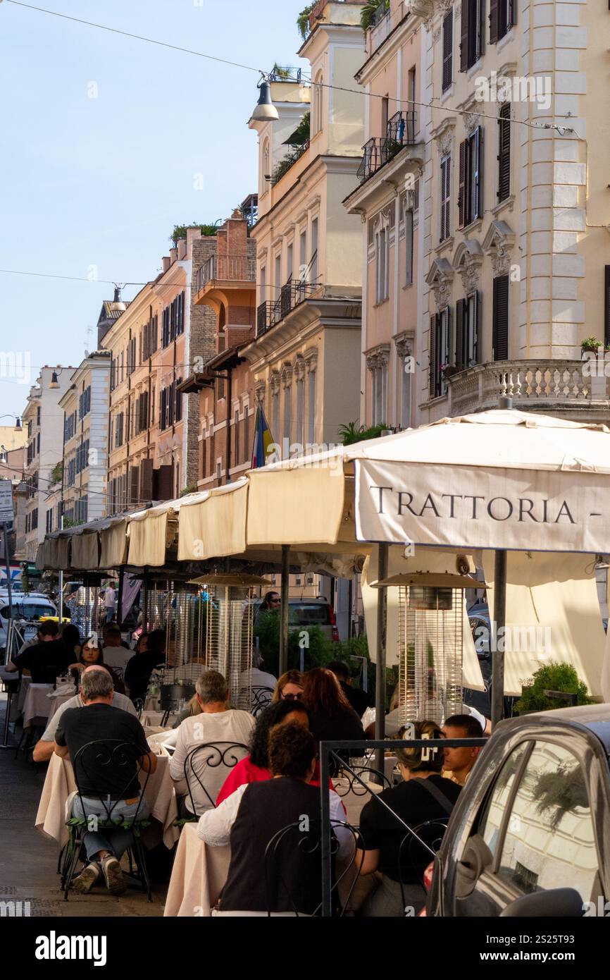 People eating in an outdoor restaurant on a street in Rome, Italy Stock ...