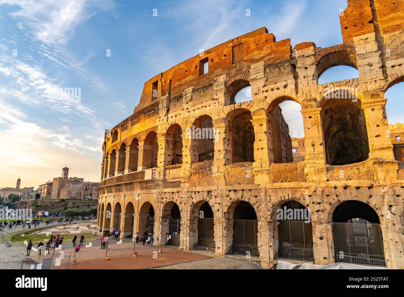 The ancient Roman Colosseum or Flavian Amphitheater with golden sunset ...
