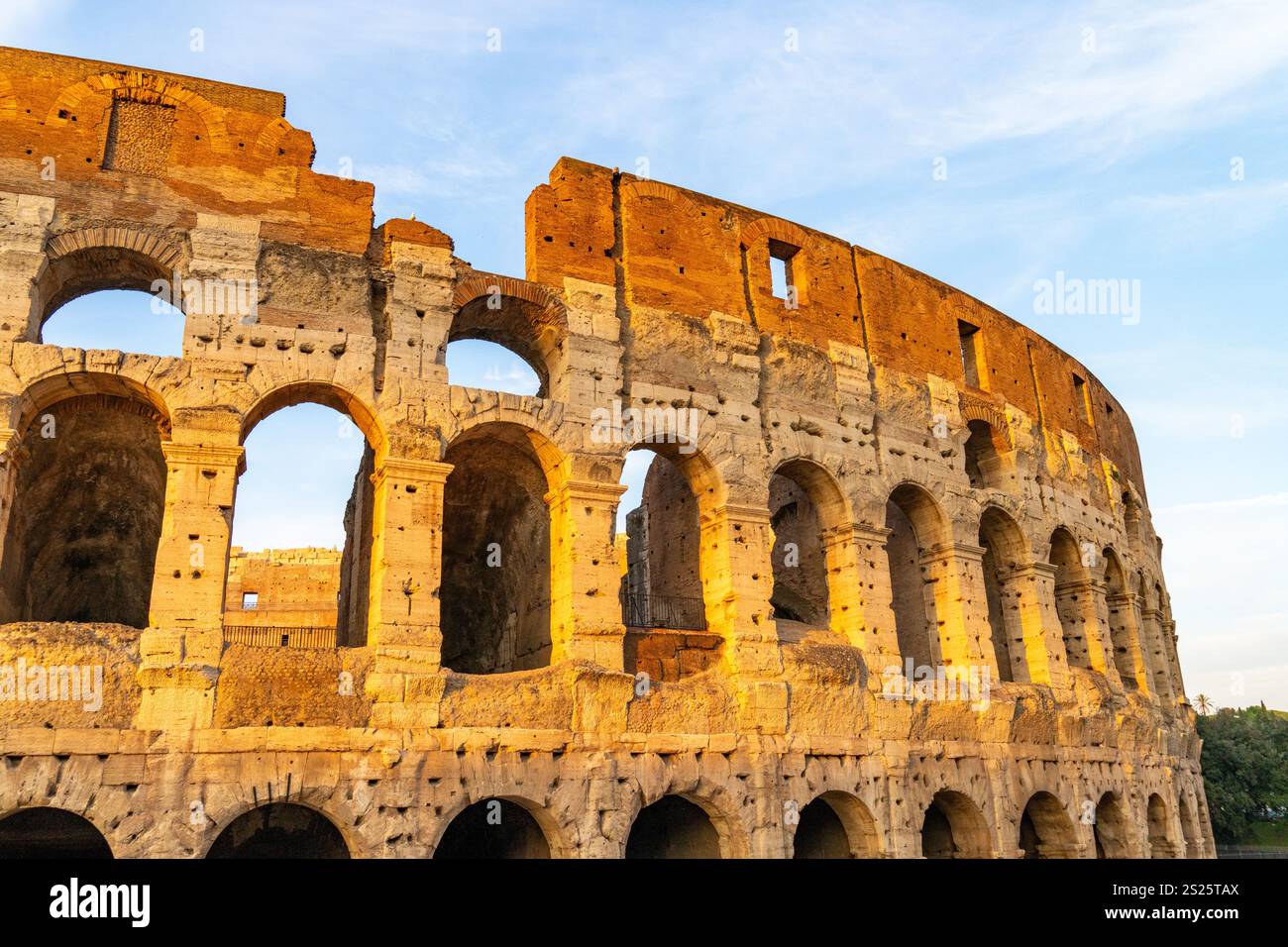 The ancient Roman Colosseum or Flavian Amphitheater with golden sunset ...