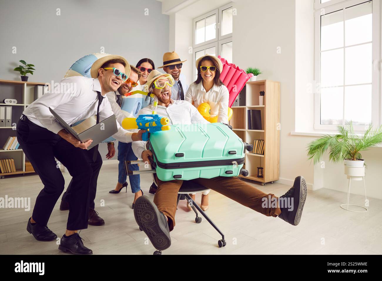 Funny happy people coworkers having fun in office with suitcase ...