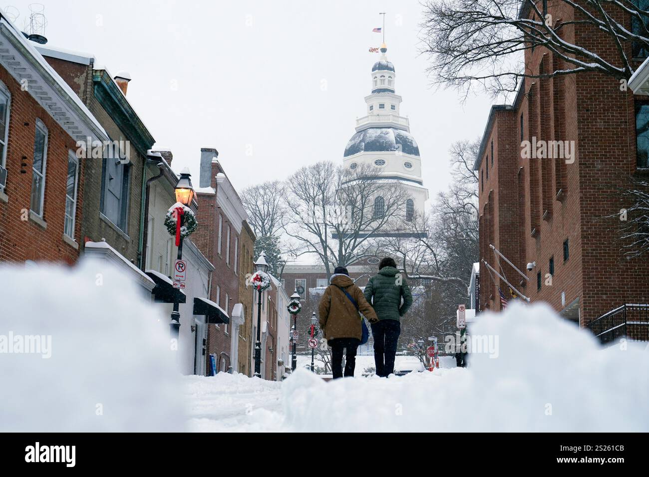 People walk the streets of Annapolis, Md., Monday, Jan. 6, 2025, during ...