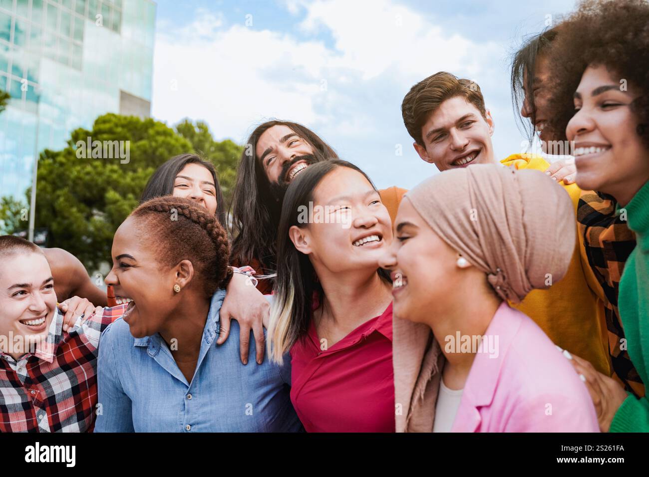 Happy group of people having fun in city. Young students enjoy together ...