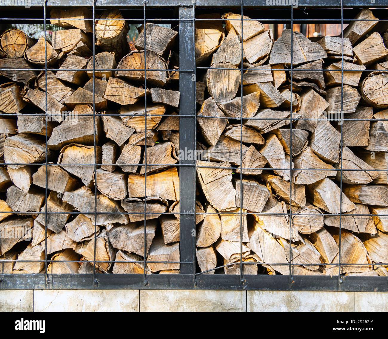 Fragment of a mesh container for storing firewood Stock Photo - Alamy