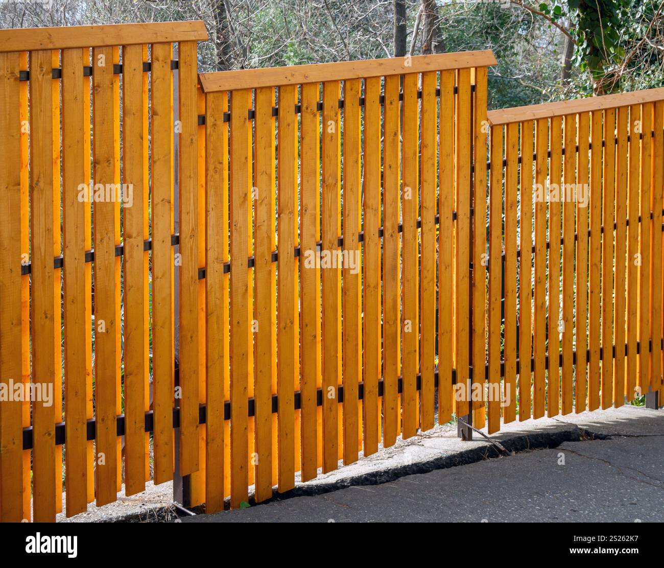 Fence made of wooden planks with double-sided cladding Stock Photo - Alamy