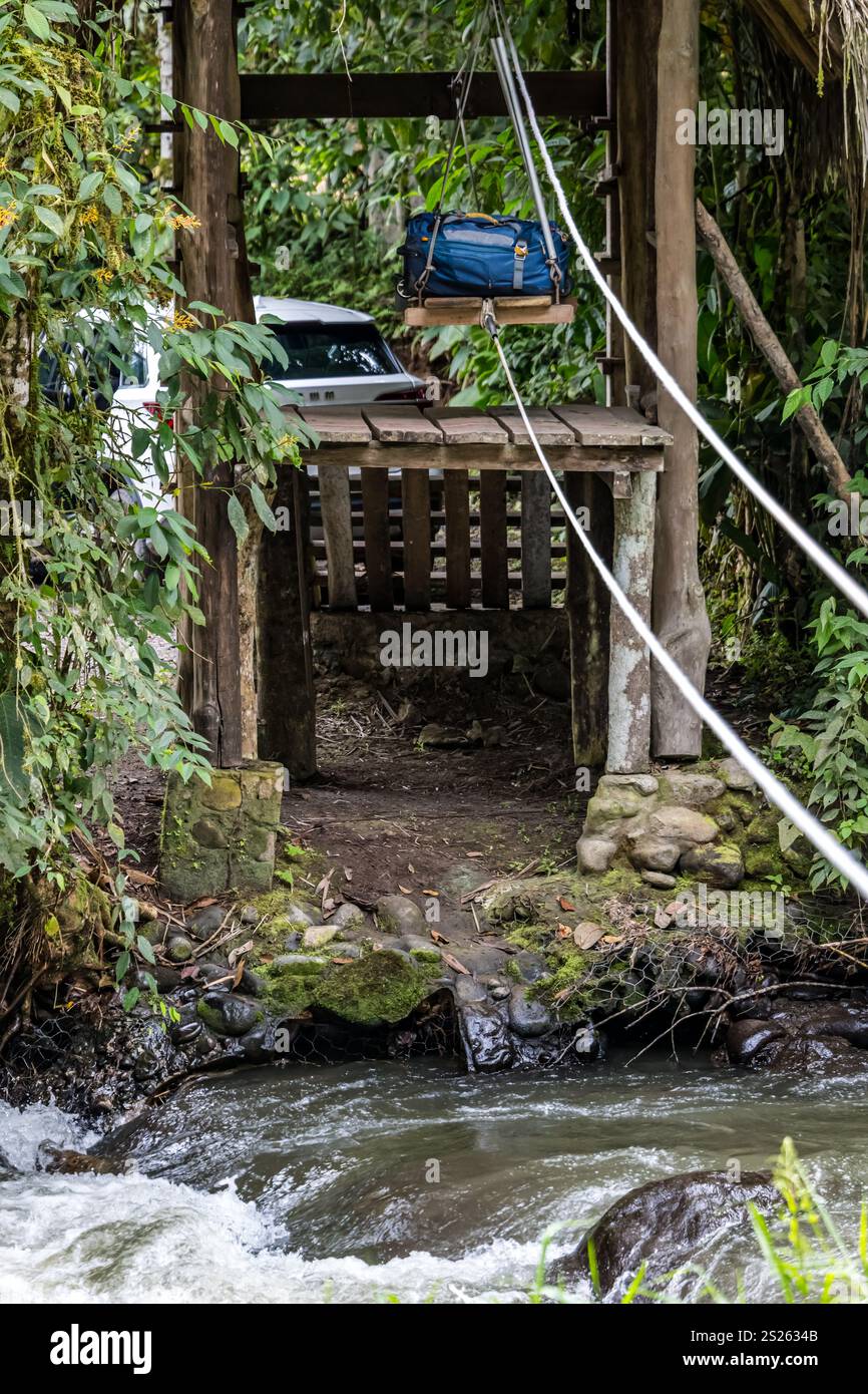 Suitcases transported across river on hand pulley at El Monte ...