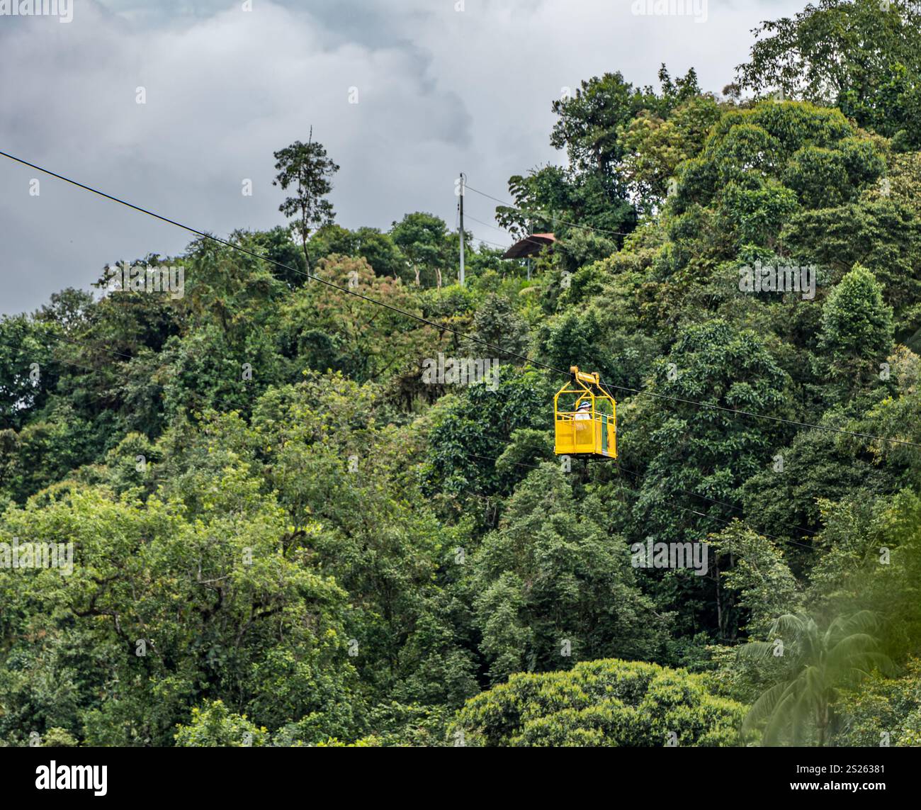 Person in cable car crossing gorge or ravine, Santuario de las Cascadas ...