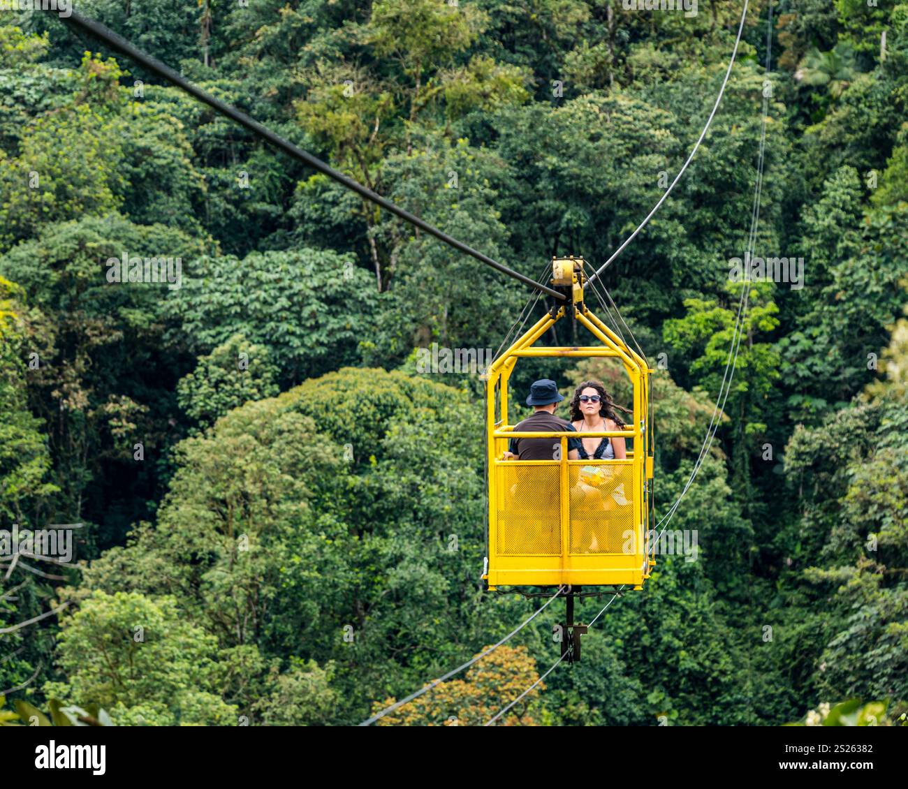 People in cable car crossing gorge or ravine, Santuario de las Cascadas ...