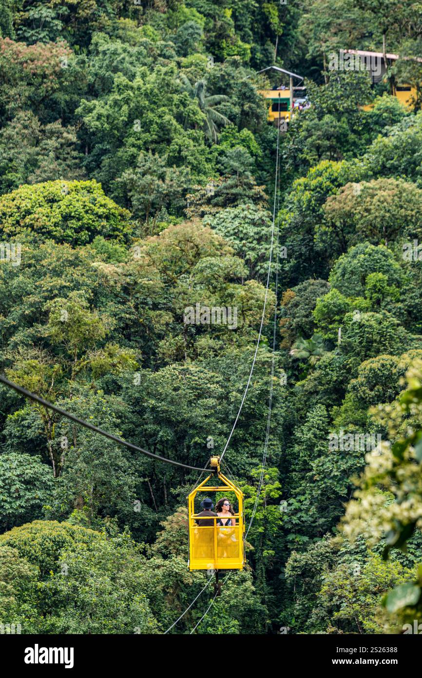 People in cable car crossing gorge or ravine, Santuario de las Cascadas ...