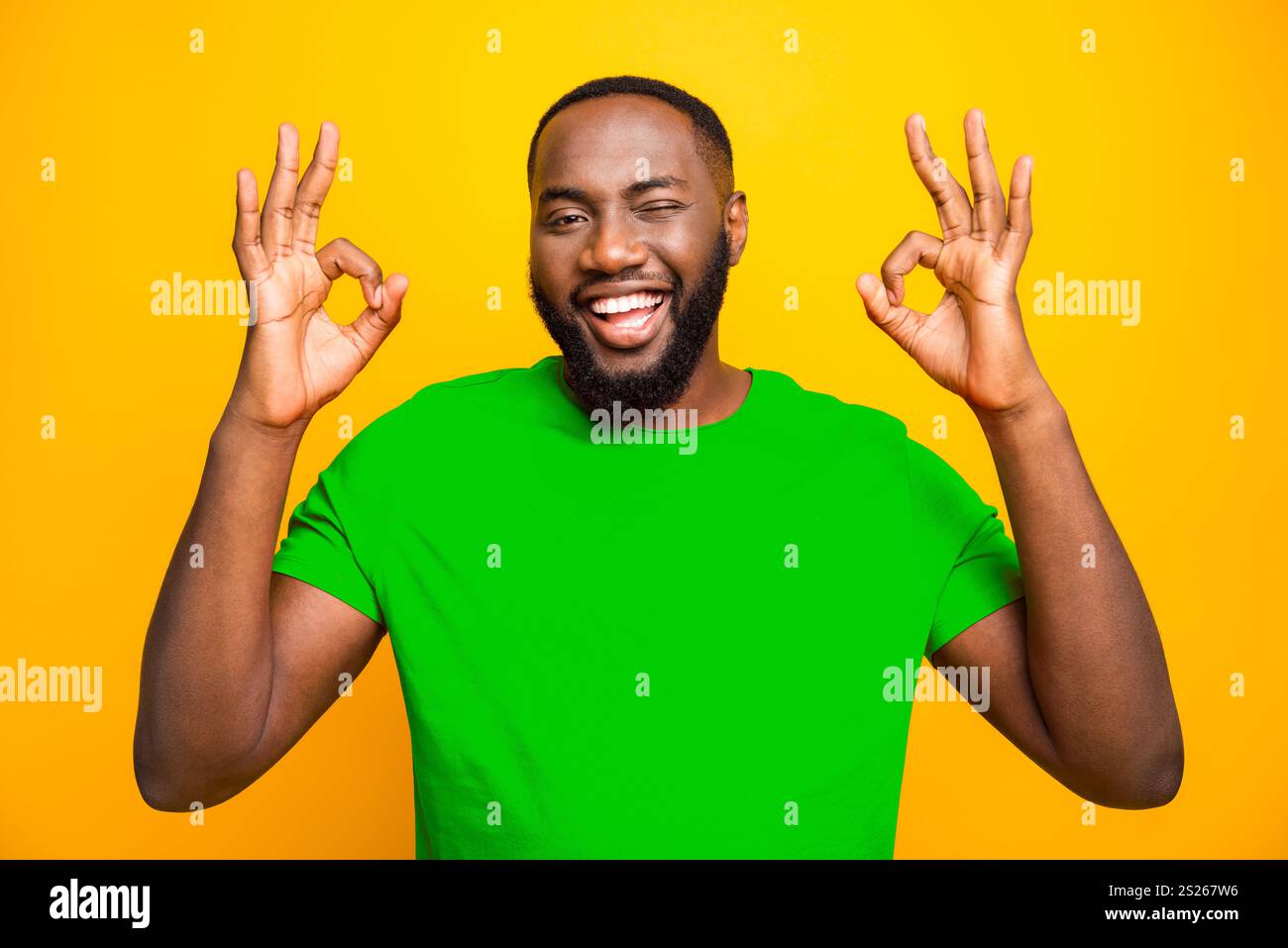 Photo of cheerful funny black man blinking you giving hint that ...