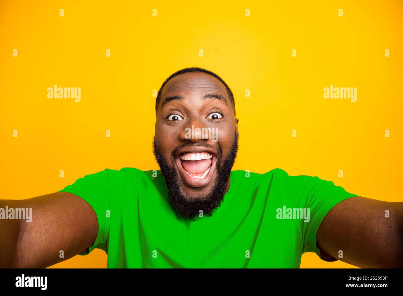Self portrait of rejoicing overjoyed black man playing new camera with ...