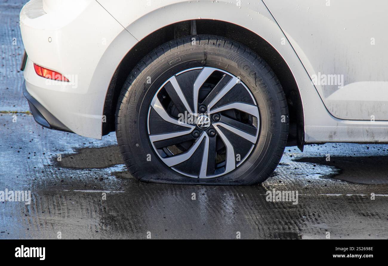 VW Car with a flat tyre or puncture Stock Photo - Alamy