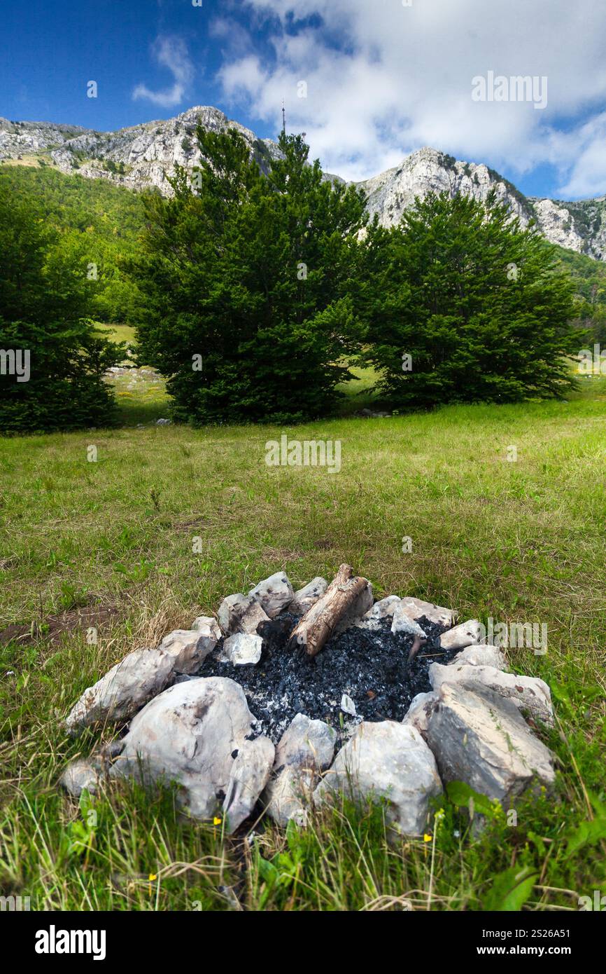 Landscape of high mountain and extinguished campfire in forest Stock ...