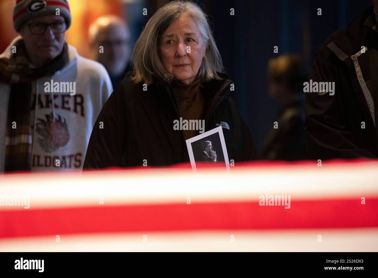 Mourners view the casket of former President Jimmy Carter as he lies in ...