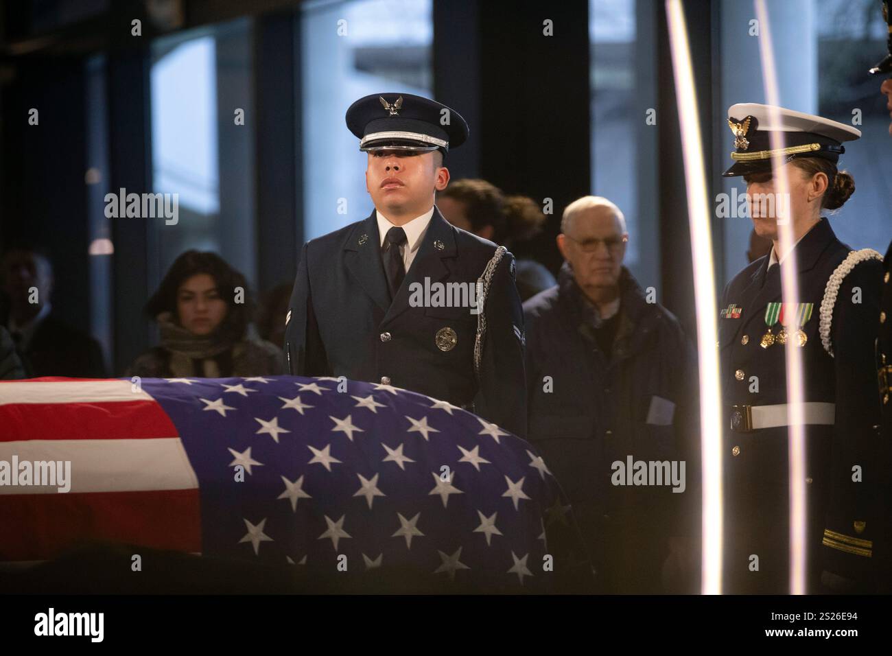 Mourners view the casket of former President Jimmy Carter as he lies in ...