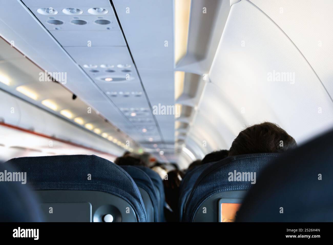 Inside the passenger plane cabin with people. Airplane travel concept ...