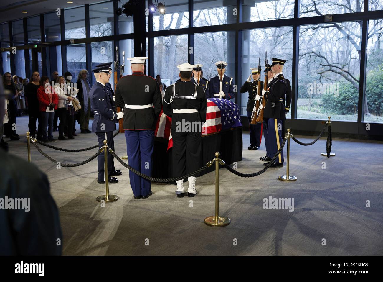 Members of the joint services military honor guard conduct a changing of the guard as mourners ...