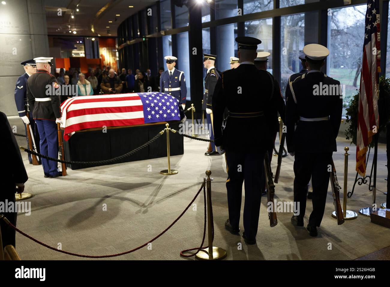 Members of the joint services military honor guard conduct a changing of the guard as mourners ...
