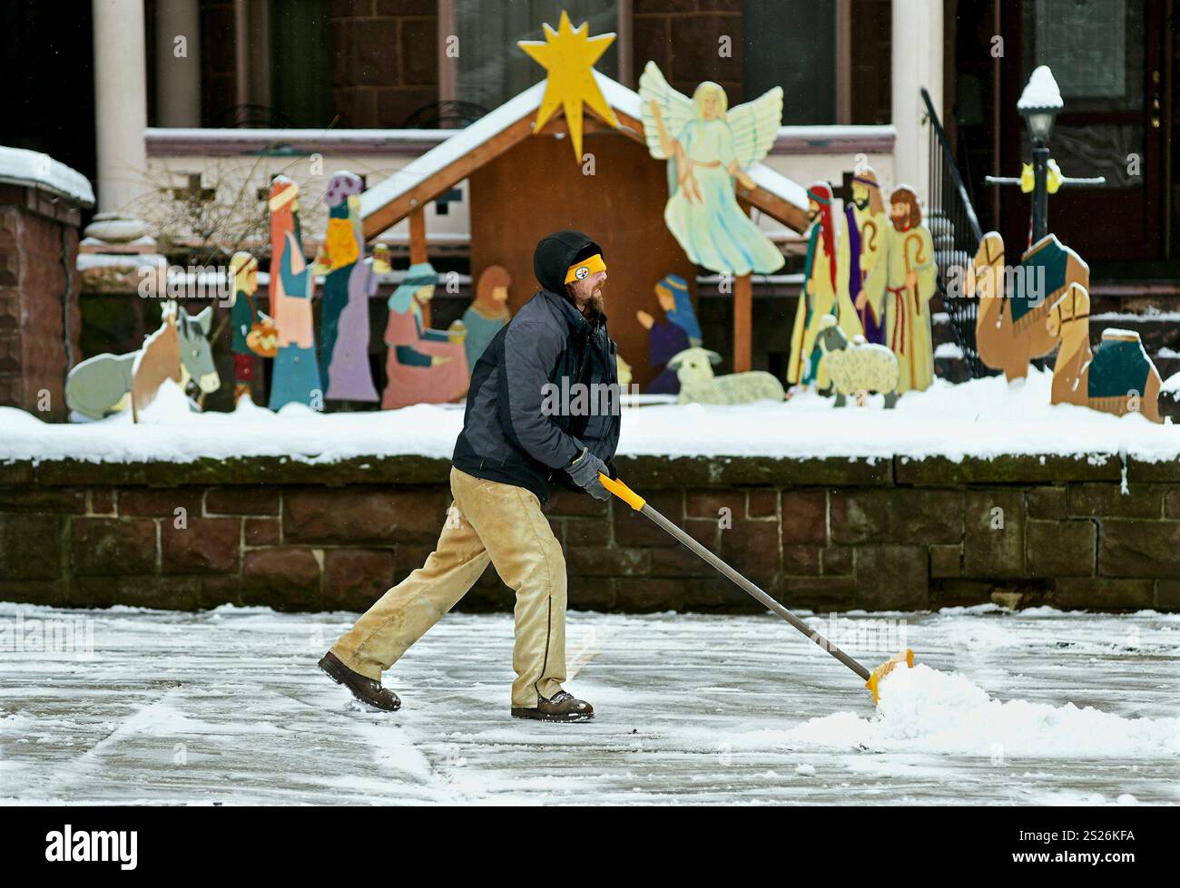 Josh Williams, of Johnstown, shovels snow from the walkway at First ...