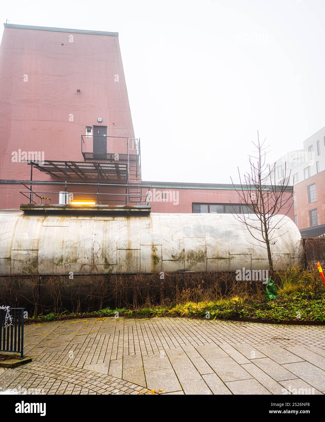 Large metal tank by a warehouse Stock Photo - Alamy