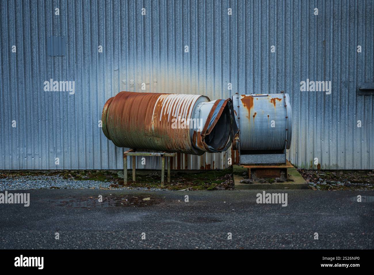 Old rusty ventilation duct by the wall of a warehouse Stock Photo - Alamy