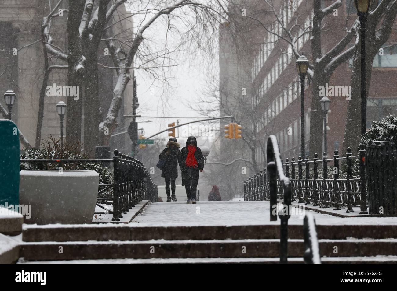 People walk through Union Square Park as snow falls heavily in New York ...