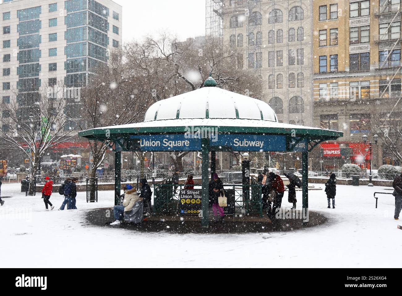 People seek shelter under subway bandshell in Union Square Park as snow ...