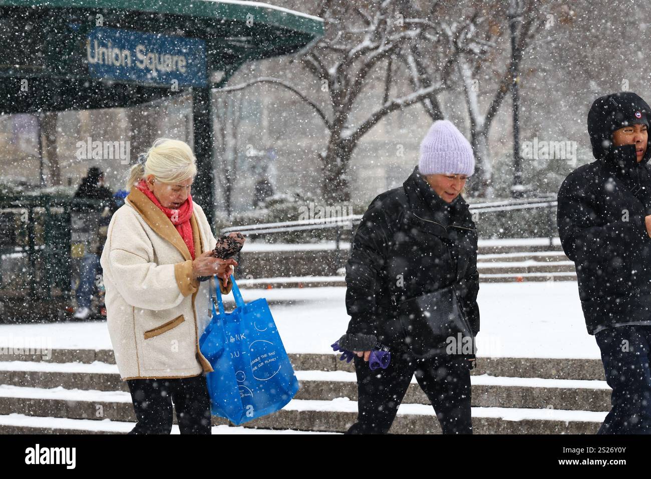 People walk through Union Square Park as the snow gets heavy in New ...