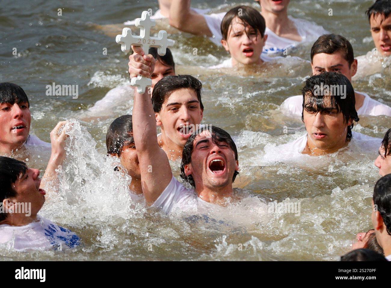 Luc Boillot, 17, of Plantation, retrieves the cross during the 119th ...