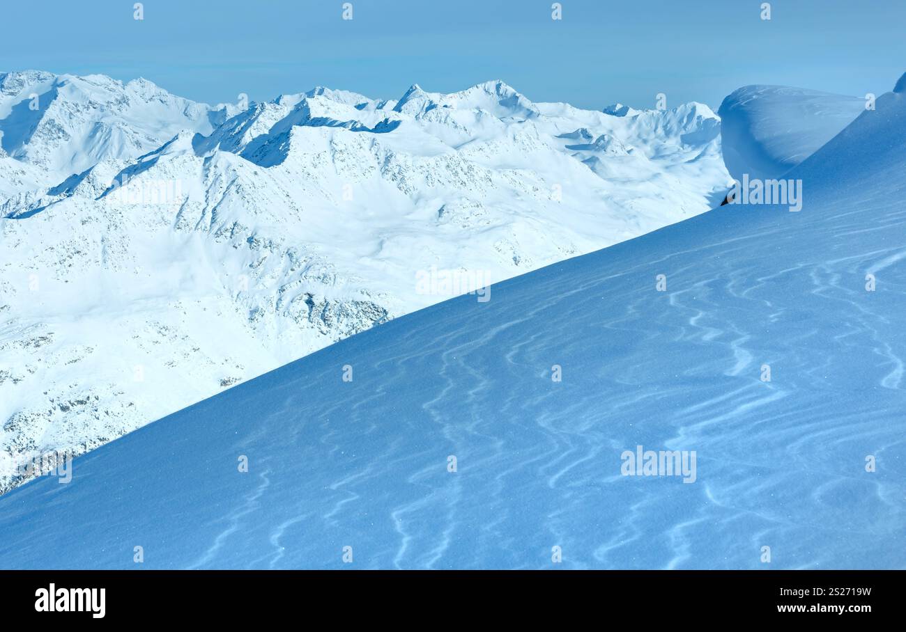 Winter mountain scenery from hill and shining snow on slope in front ...