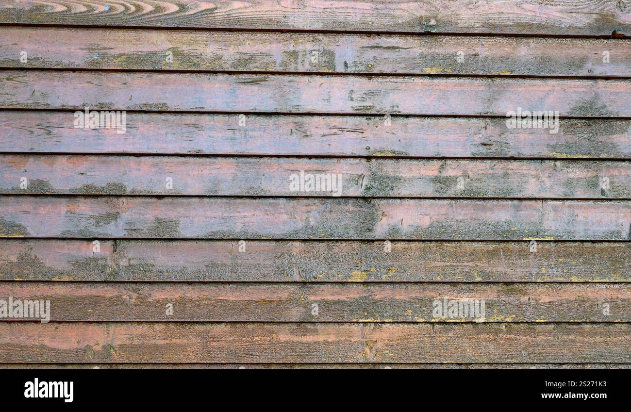 The close-up view showcases a weathered wooden wall with distinct grain ...