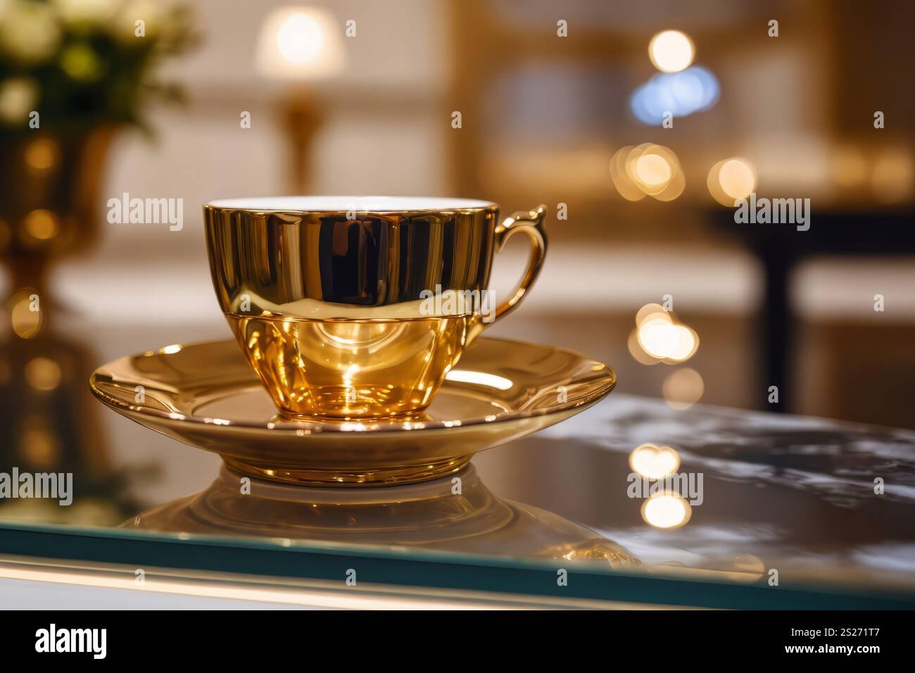 Elegant Golden Tea Cup on Reflective Surface Under Warm Lighting Stock ...