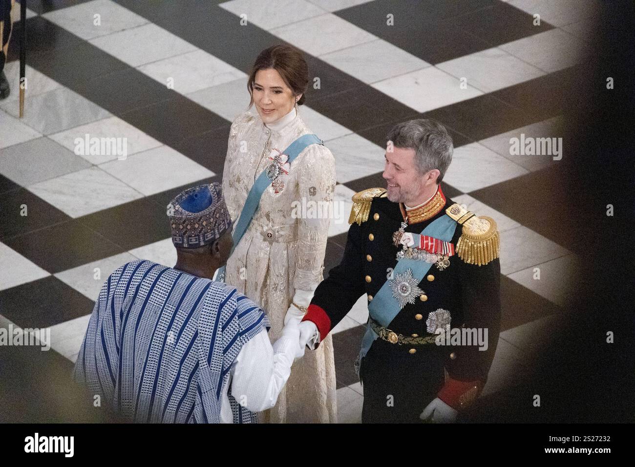 Denmark s Queen Mary L and King Frederik X R shake hands with the ambassador and the guests ...